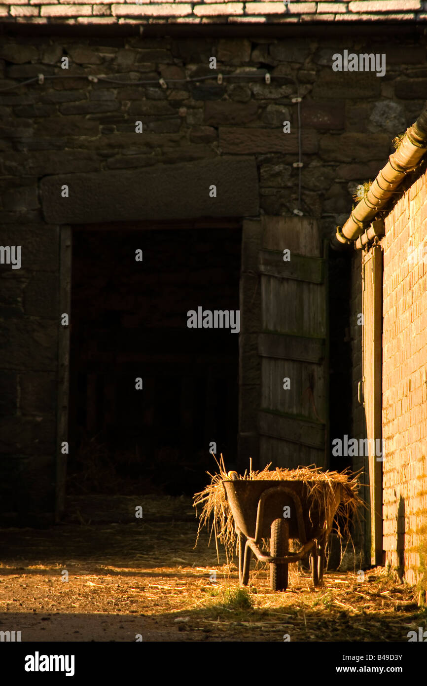 Wheelbarrow beside a barn Stock Photo - Alamy