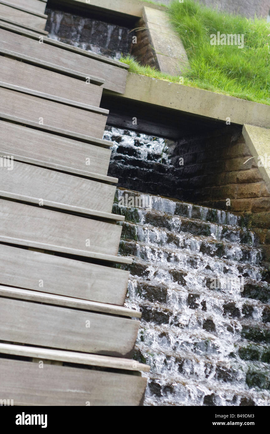 green oak steps set by water feature and grassed are.Garden feature for ...
