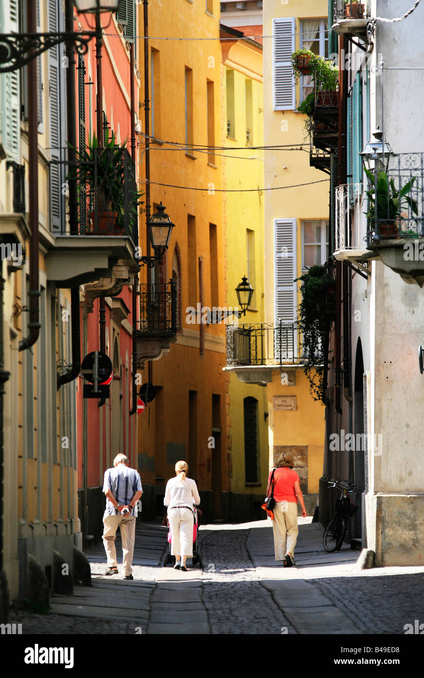 Family strolling through medieval streets, Cuneo, Piemonte Italy Stock ...