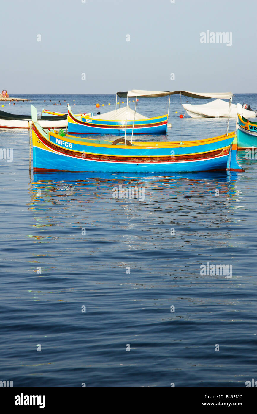 Maltese Luzzu fishing boats in St Thomas Bay, Marsaskala Stock Photo ...