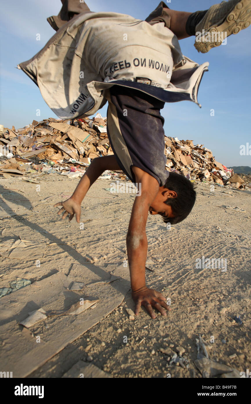 Roma gypsy boy doing handstand at Share, a slum next to a rubbish dump ...