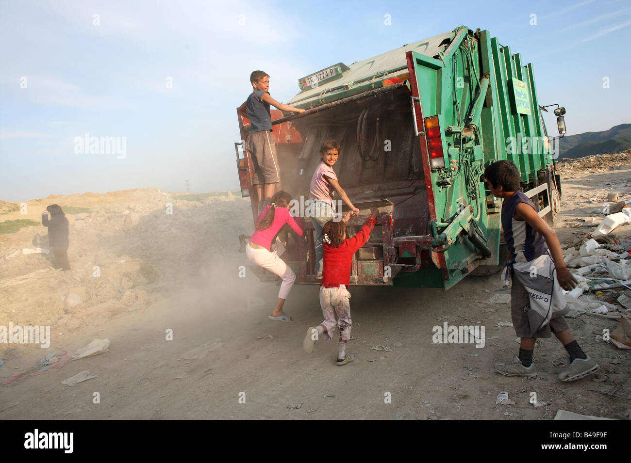Children riding a dumpster in Sharre, a slum next to a rubbish dump on ...