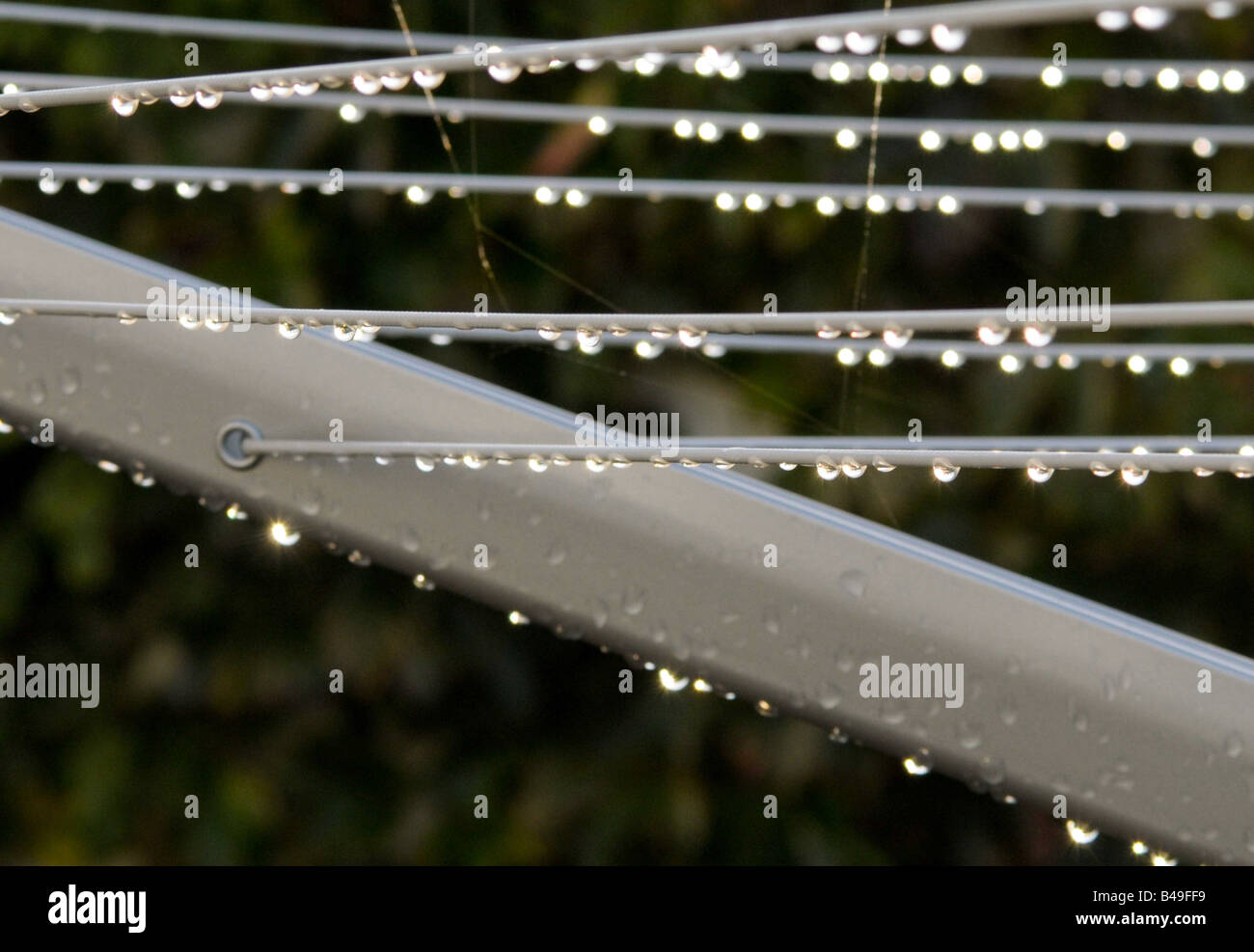 Rain drops on rotary washing line Stock Photo - Alamy
