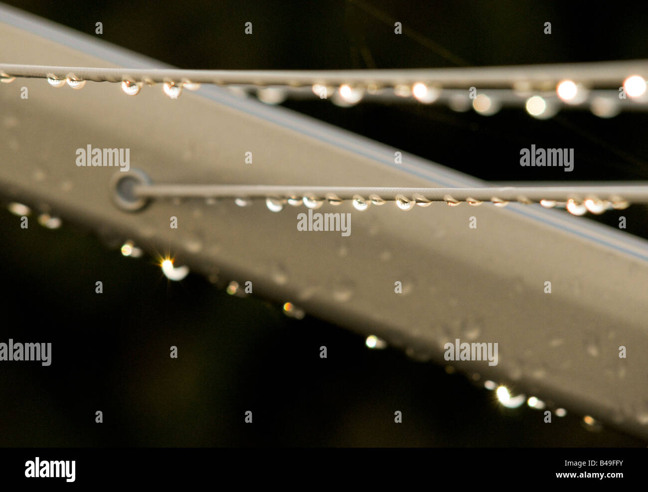Rain drops on rotary washing line Stock Photo - Alamy