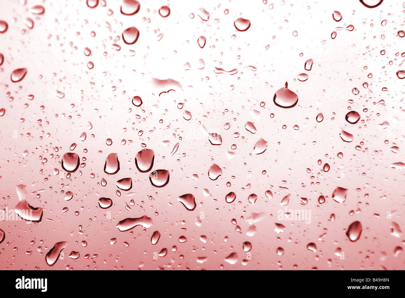 water drops on a window Red Tone Stock Photo - Alamy