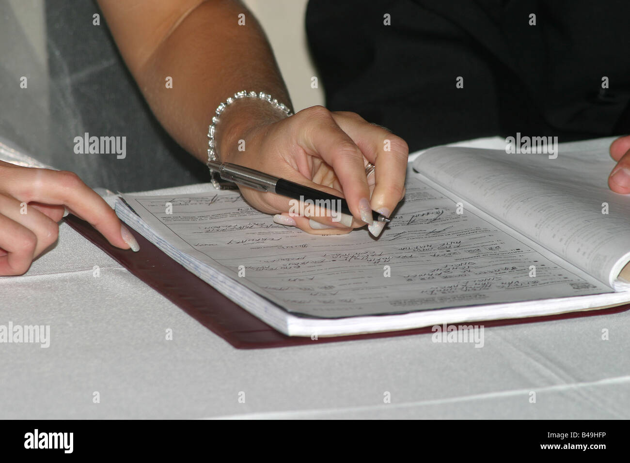 New bride signing the register Stock Photo - Alamy