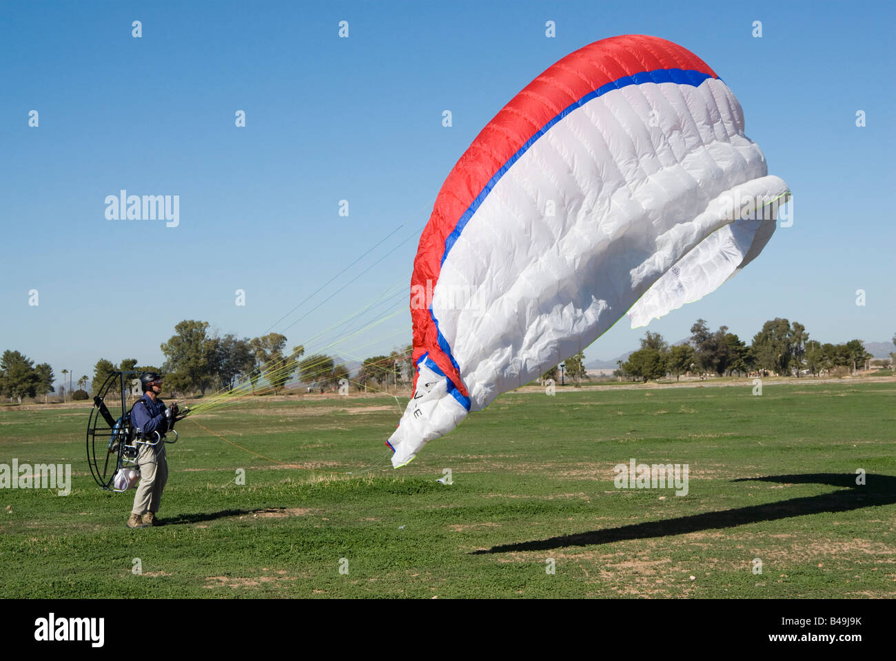 a powered paraglider pilot prepares to take off Stock Photo - Alamy
