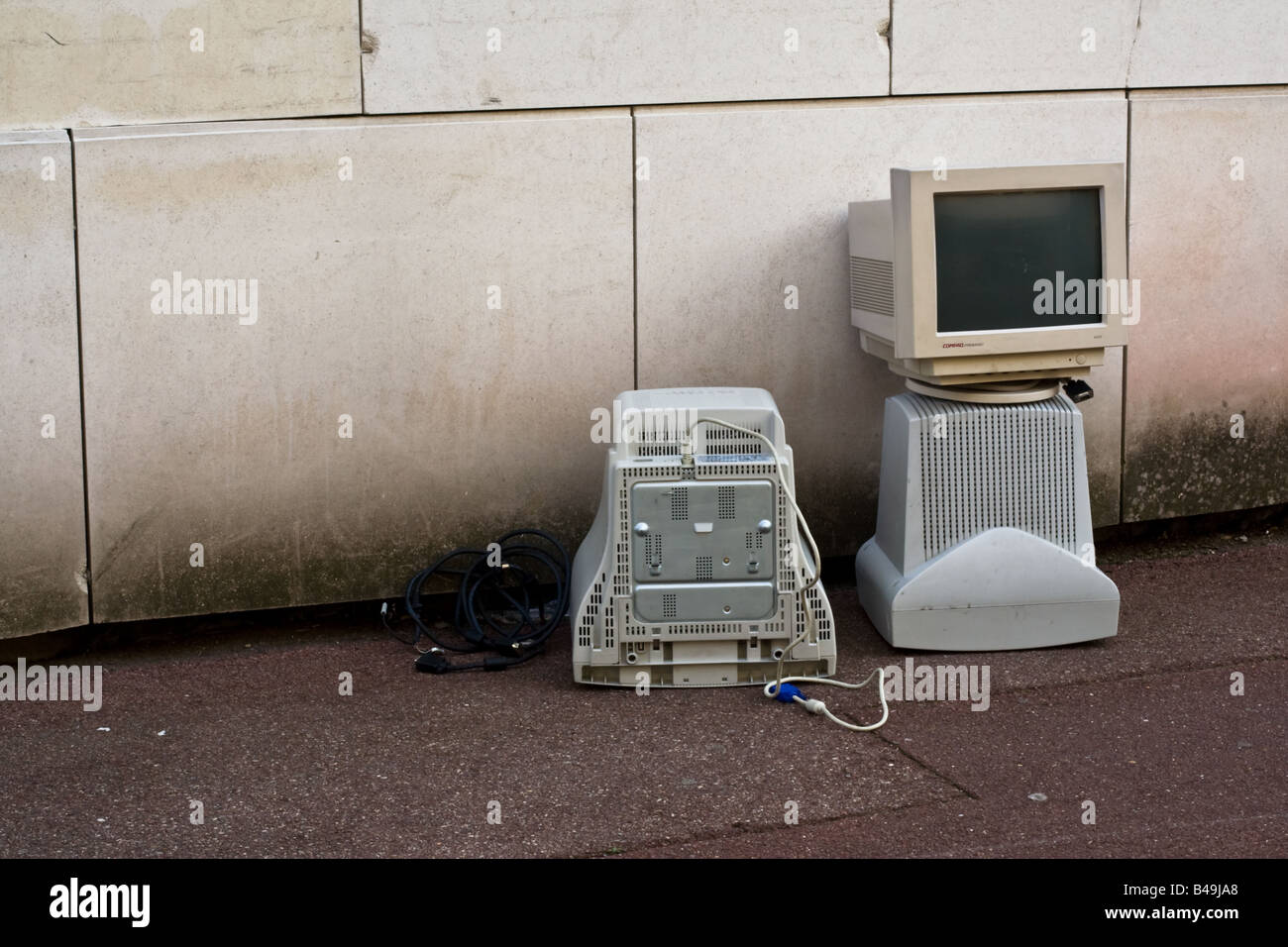 Three old obsolete computer screen monitors discarded as junk on the ...