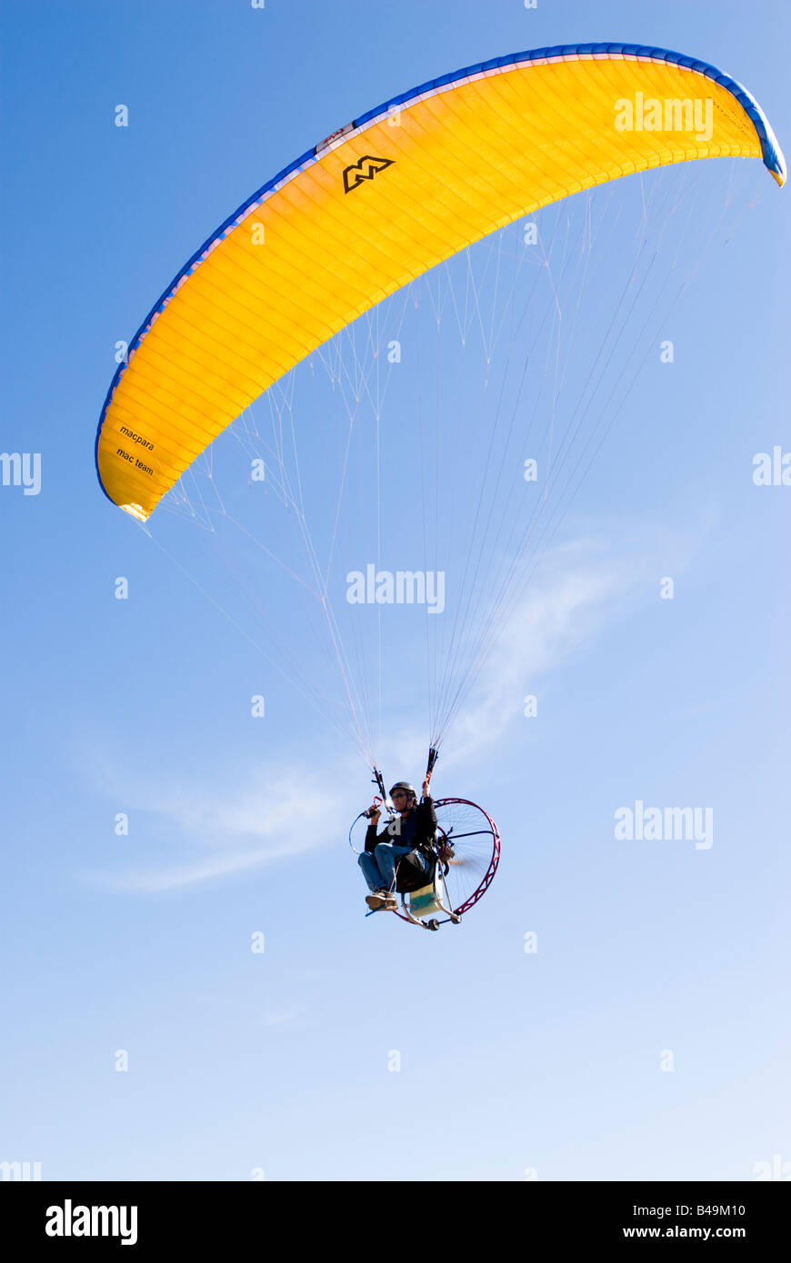 a powered paragliders in flight against a clear blue sky Stock Photo ...