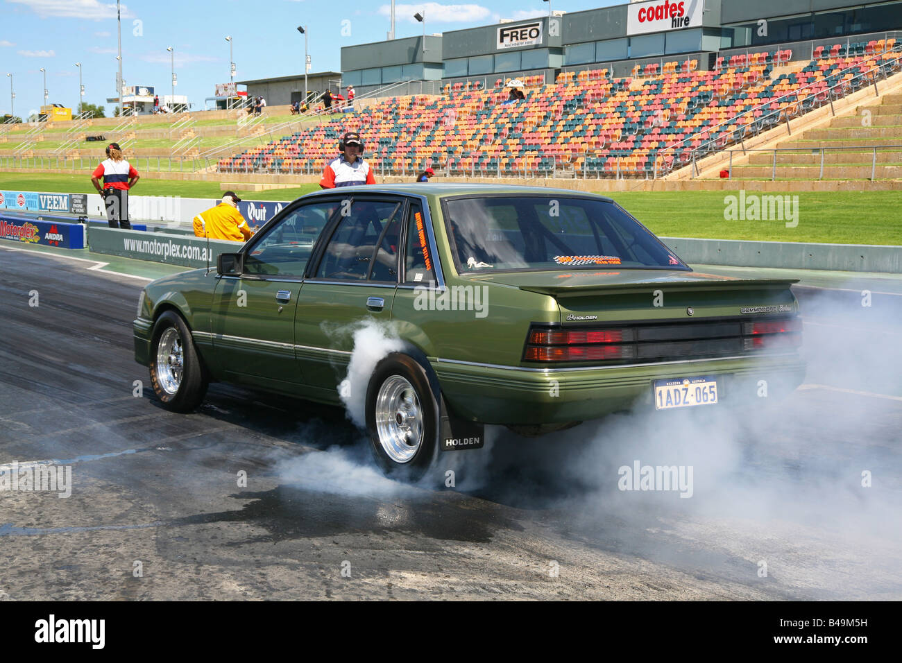 An Australian Holden Commodore performs a tyre smoking burnout to warm ...