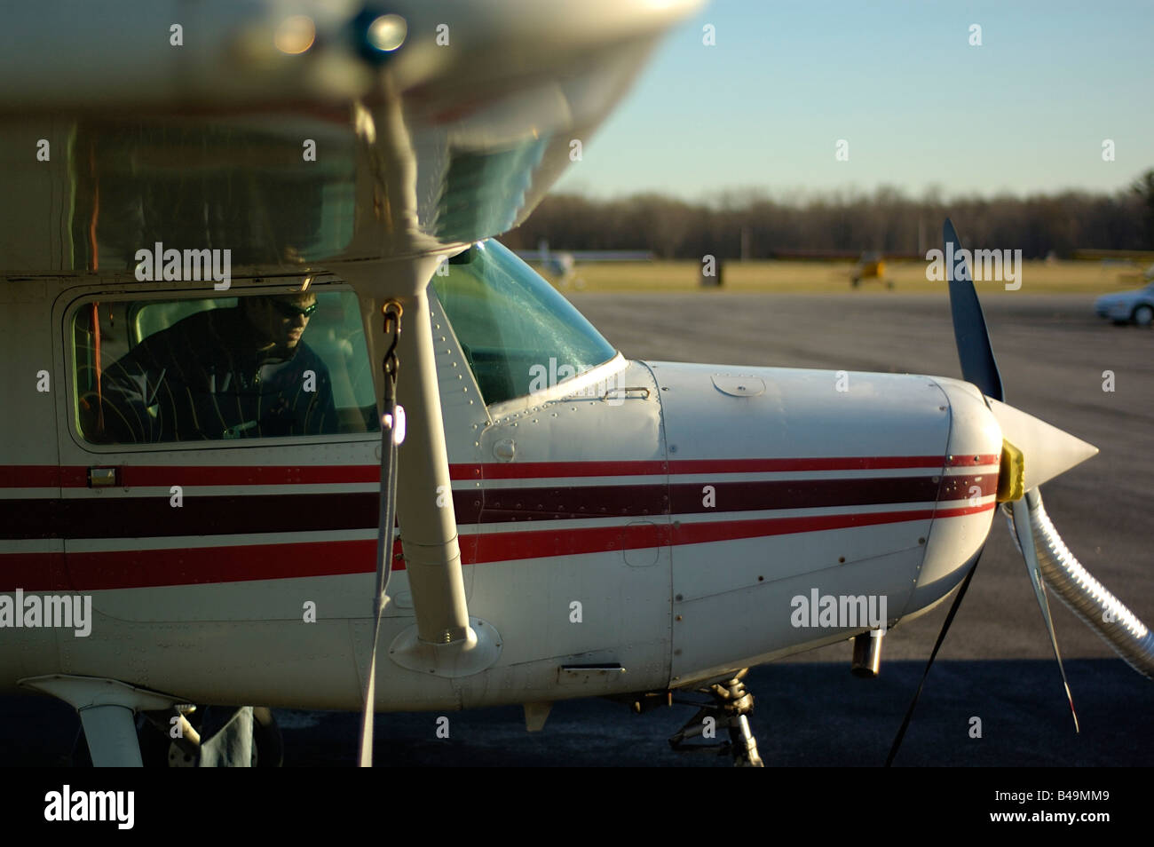Pilot performs preflight check on a small single engine aircraft while ...