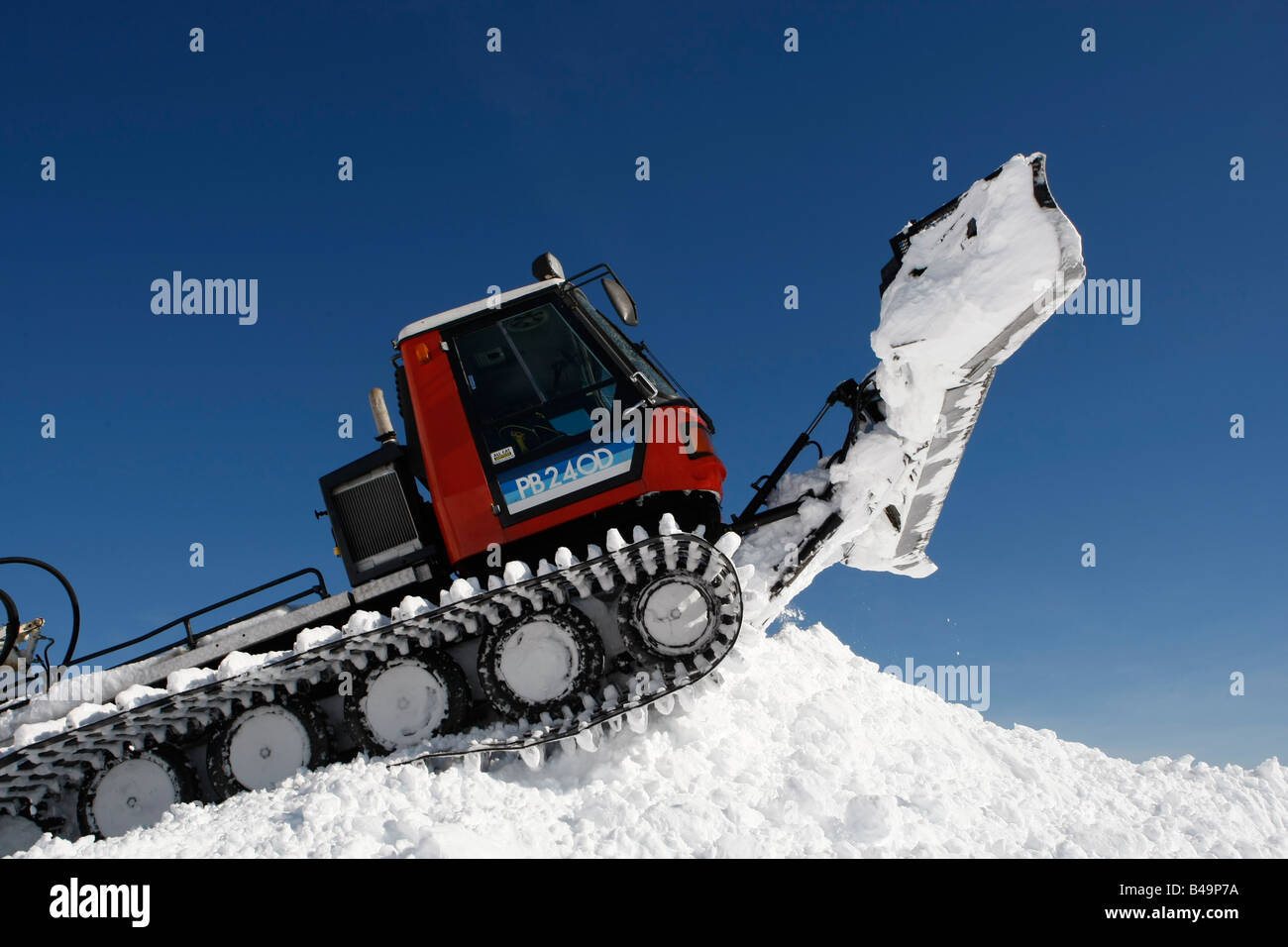 snow cat ploughing snow to build a snowboard jump Stock Photo - Alamy