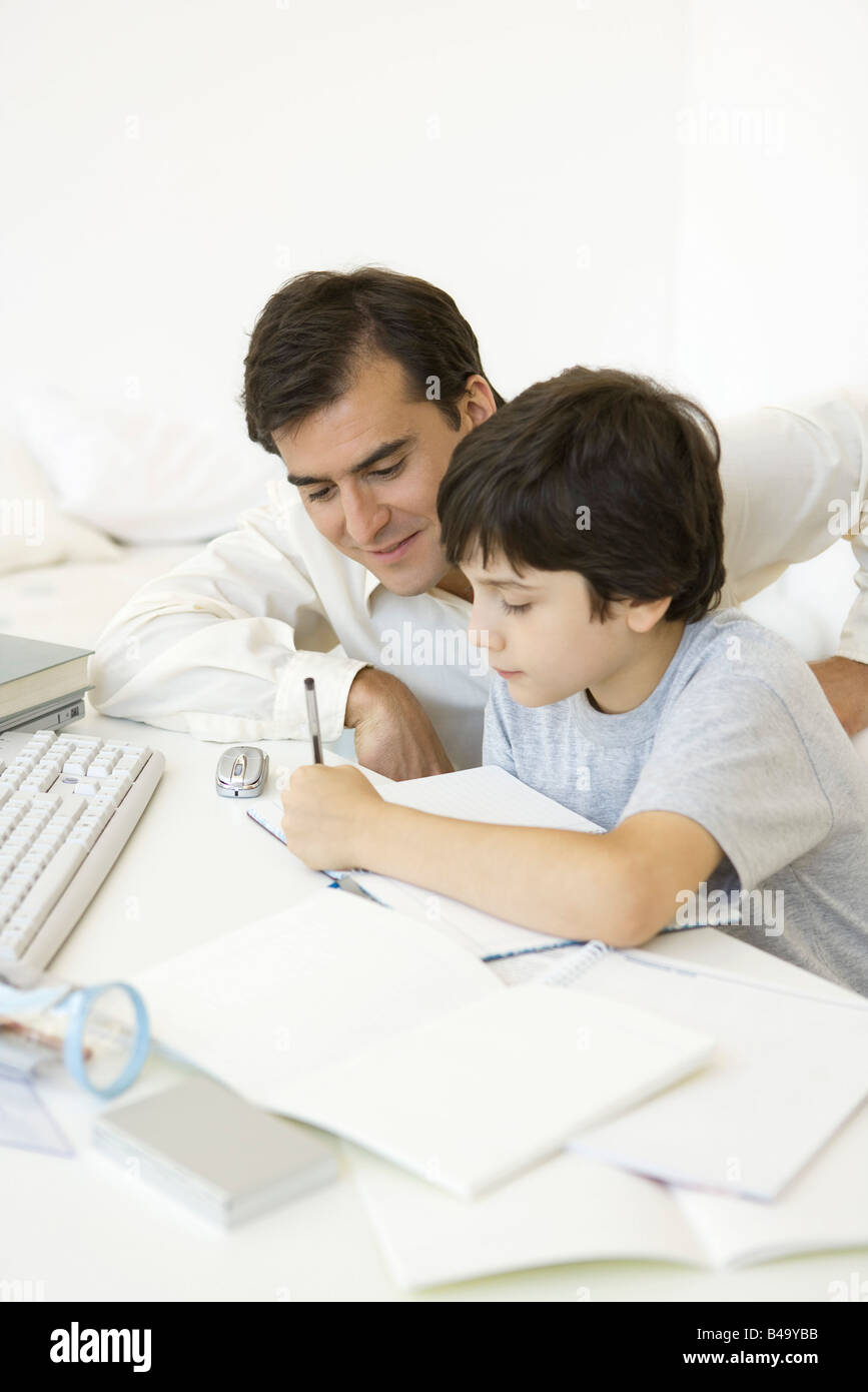 Father helping son with his homework Stock Photo - Alamy