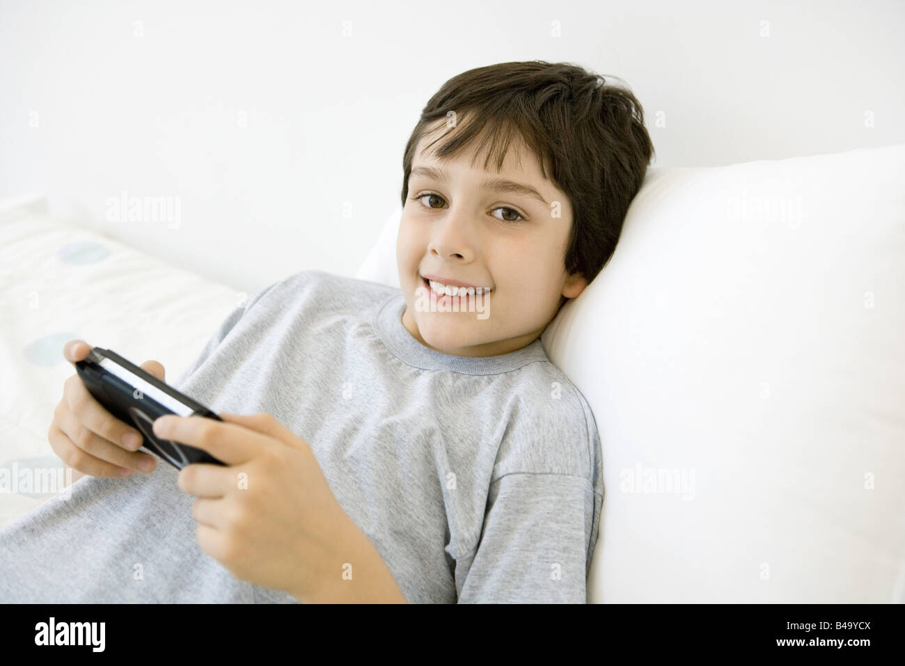Kids playing handheld video game hi-res stock photography and images ...