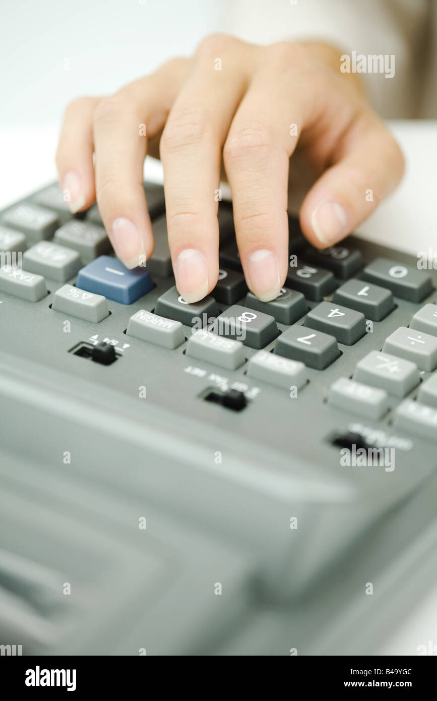 Woman's hand using adding machine, close-up Stock Photo - Alamy