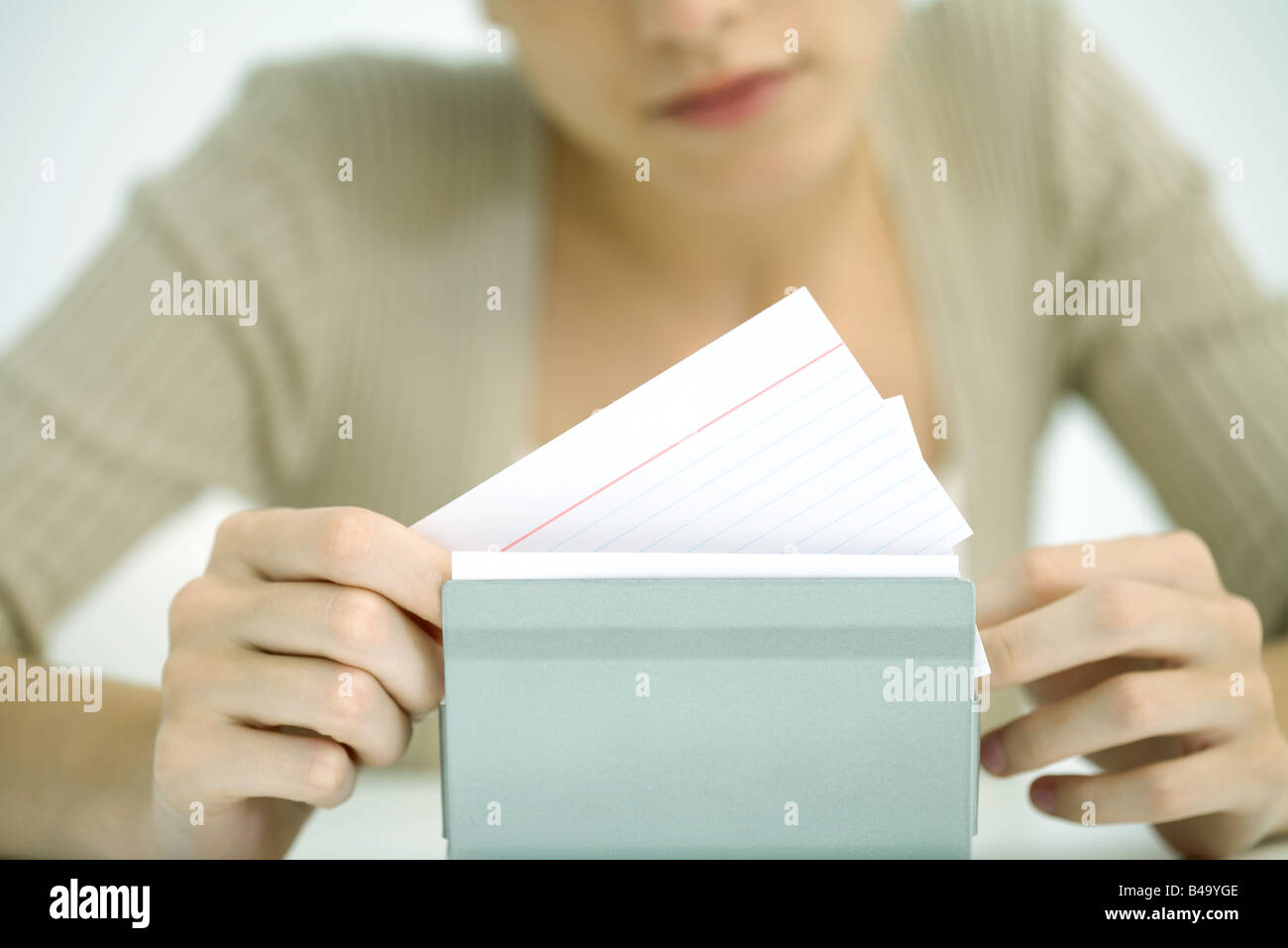 Woman flipping through card file, cropped view Stock Photo - Alamy