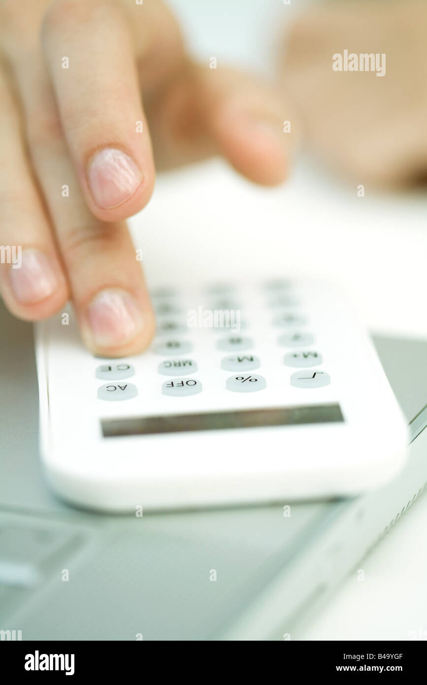 Woman's hand using calculator, extreme close-up Stock Photo - Alamy