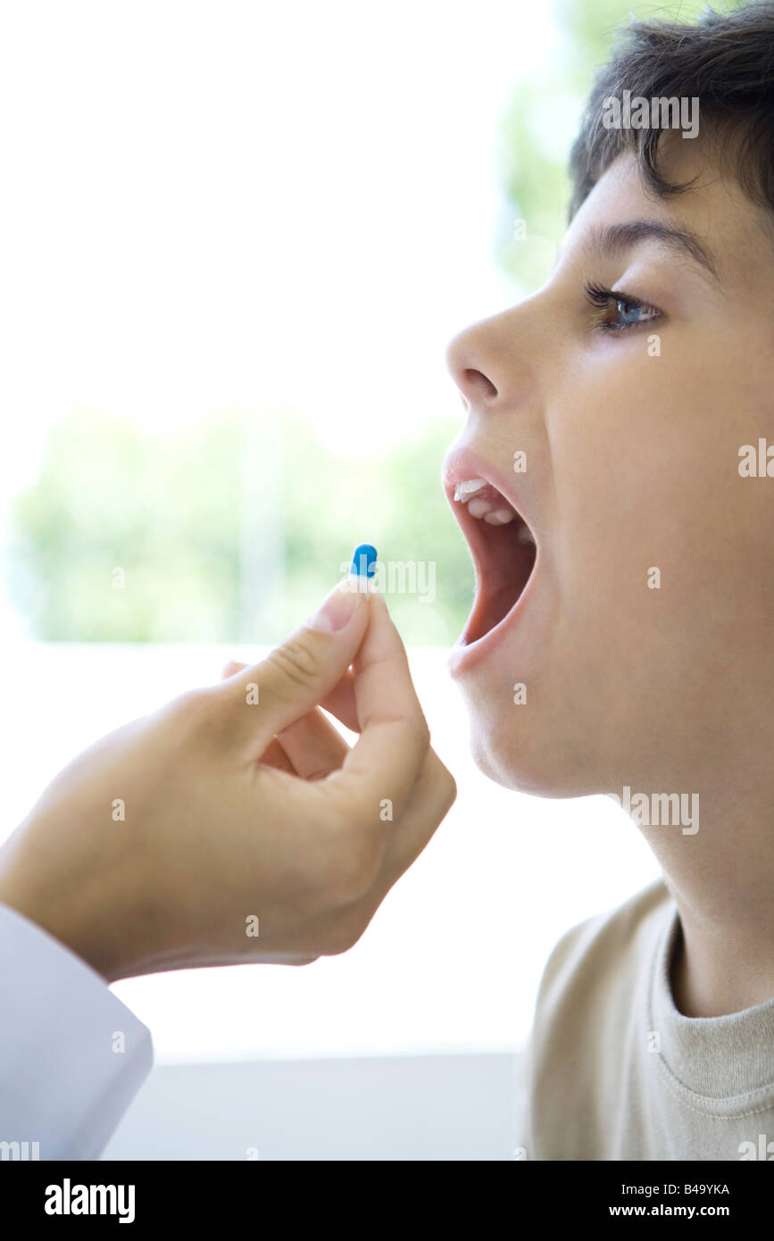 Child accepting pill with open mouth, cropped view Stock Photo - Alamy