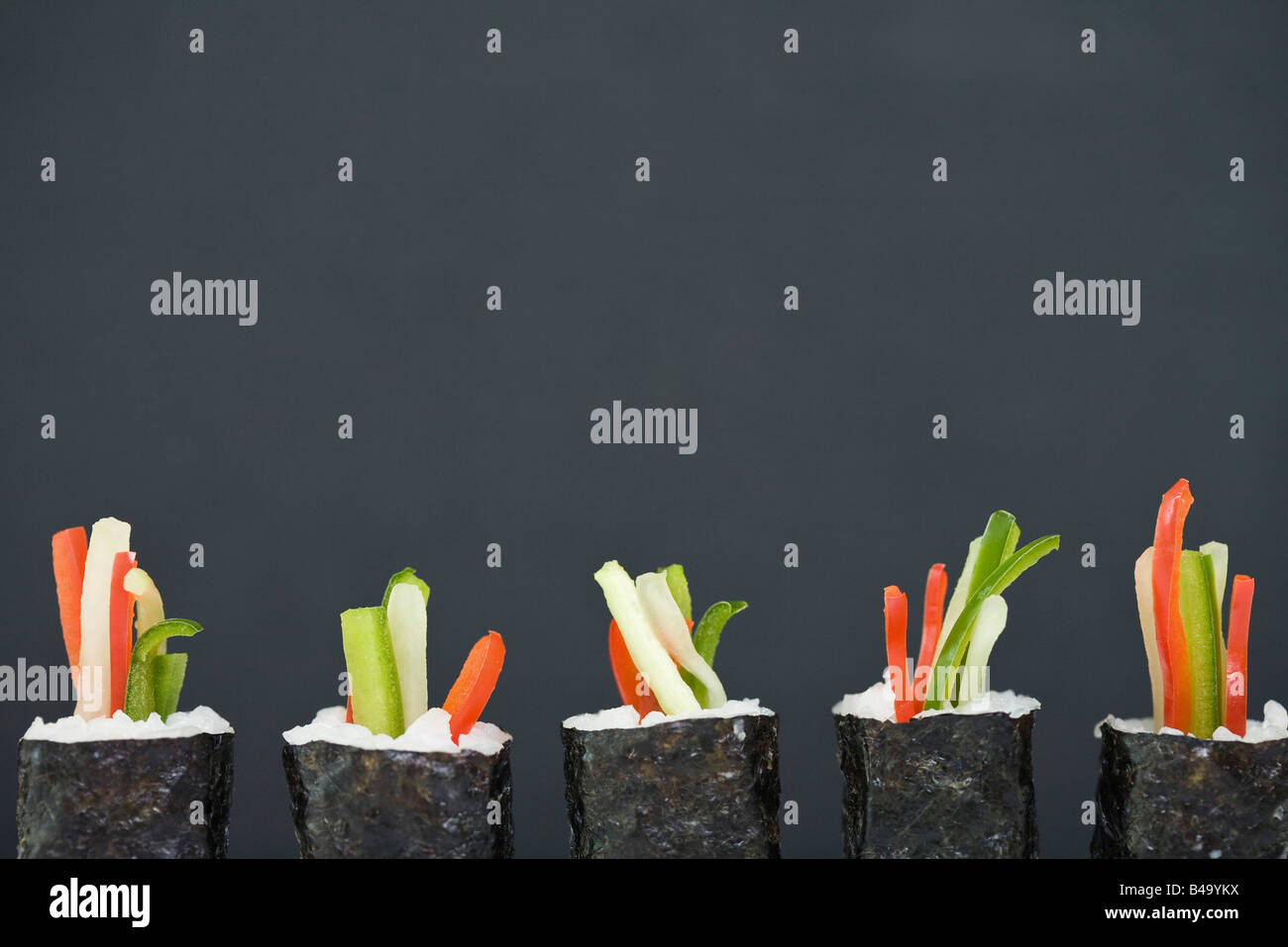 Row of colorful maki sushi, side view Stock Photo - Alamy