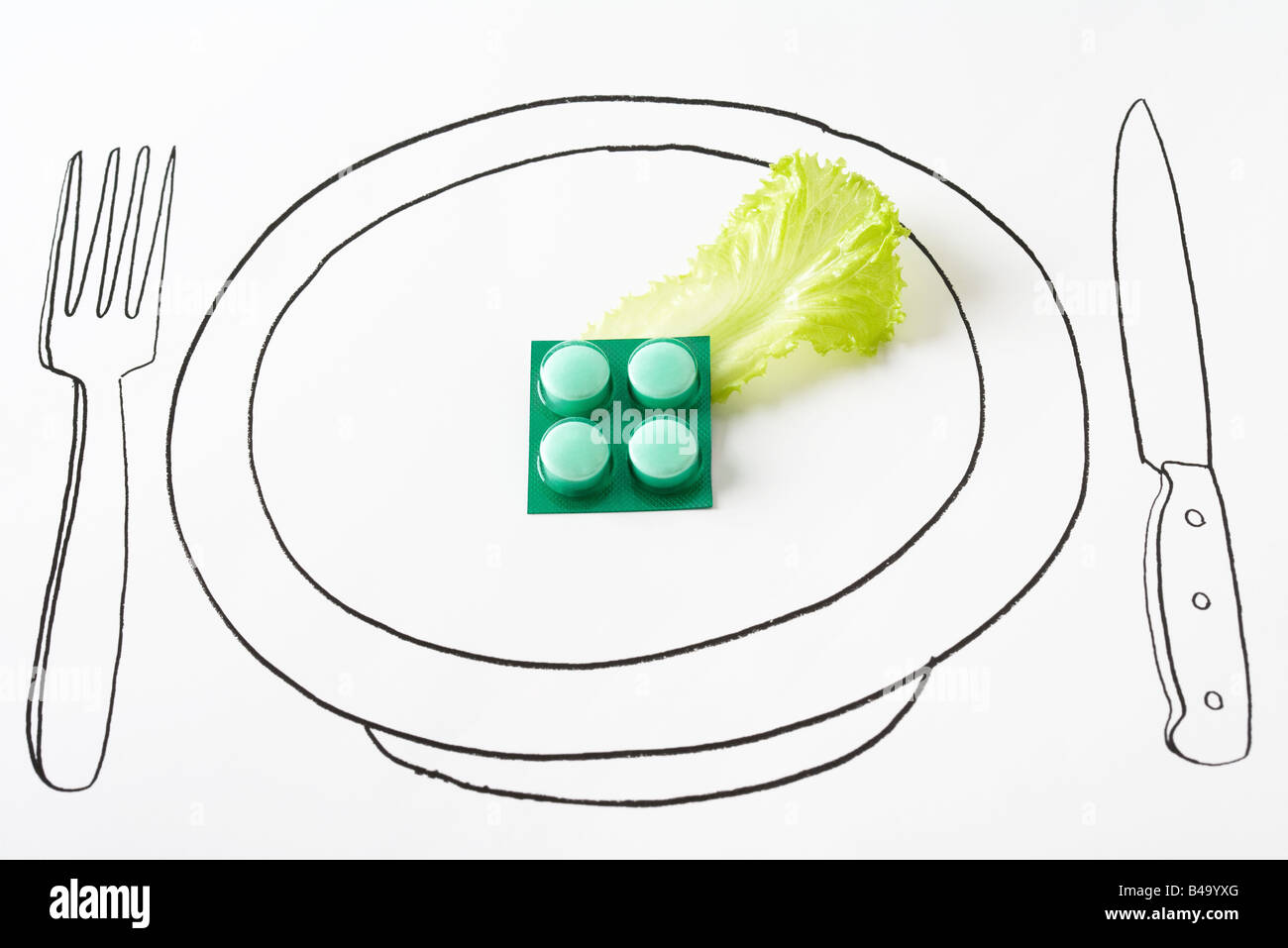 Blister pack of pills and single piece of lettuce on plate Stock Photo ...
