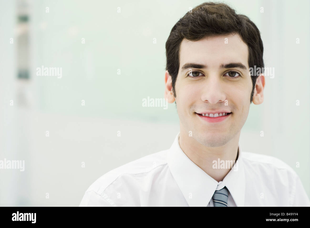Young businessman smiling at camera, portrait Stock Photo - Alamy