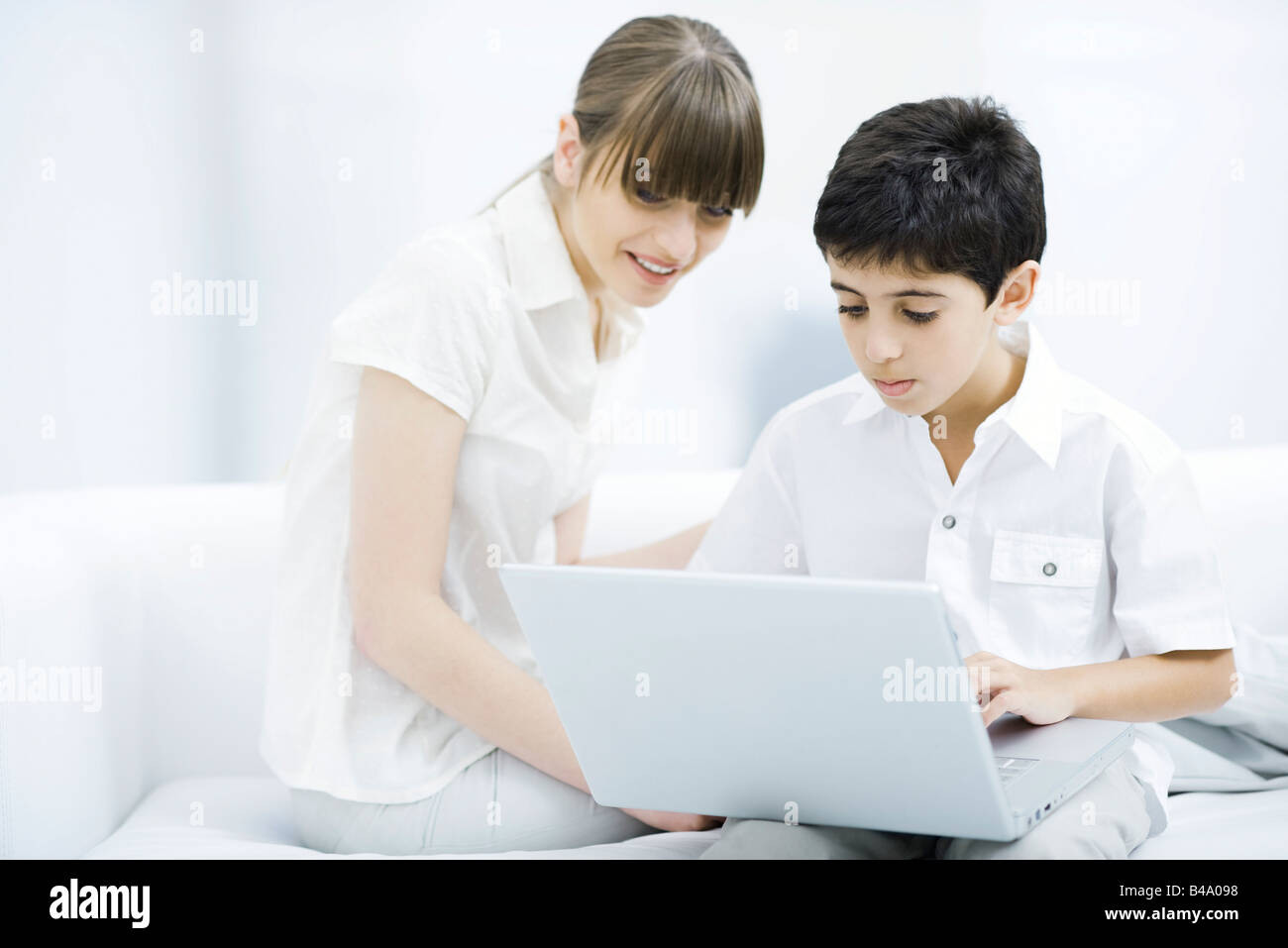 Mother and son looking at laptop computer together Stock Photo - Alamy
