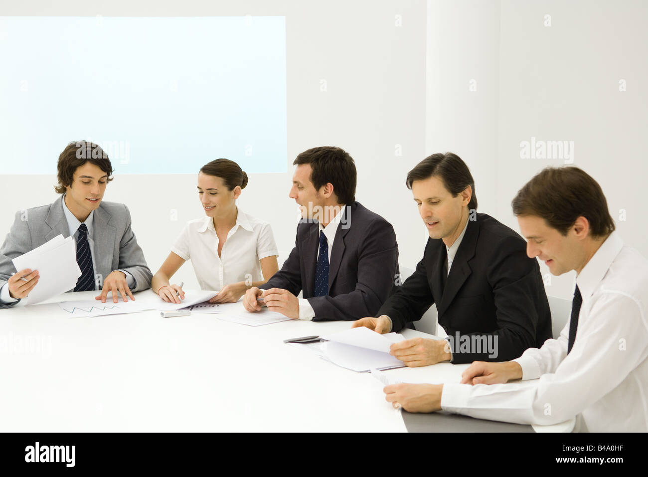 Business people in meeting, reviewing documents Stock Photo - Alamy