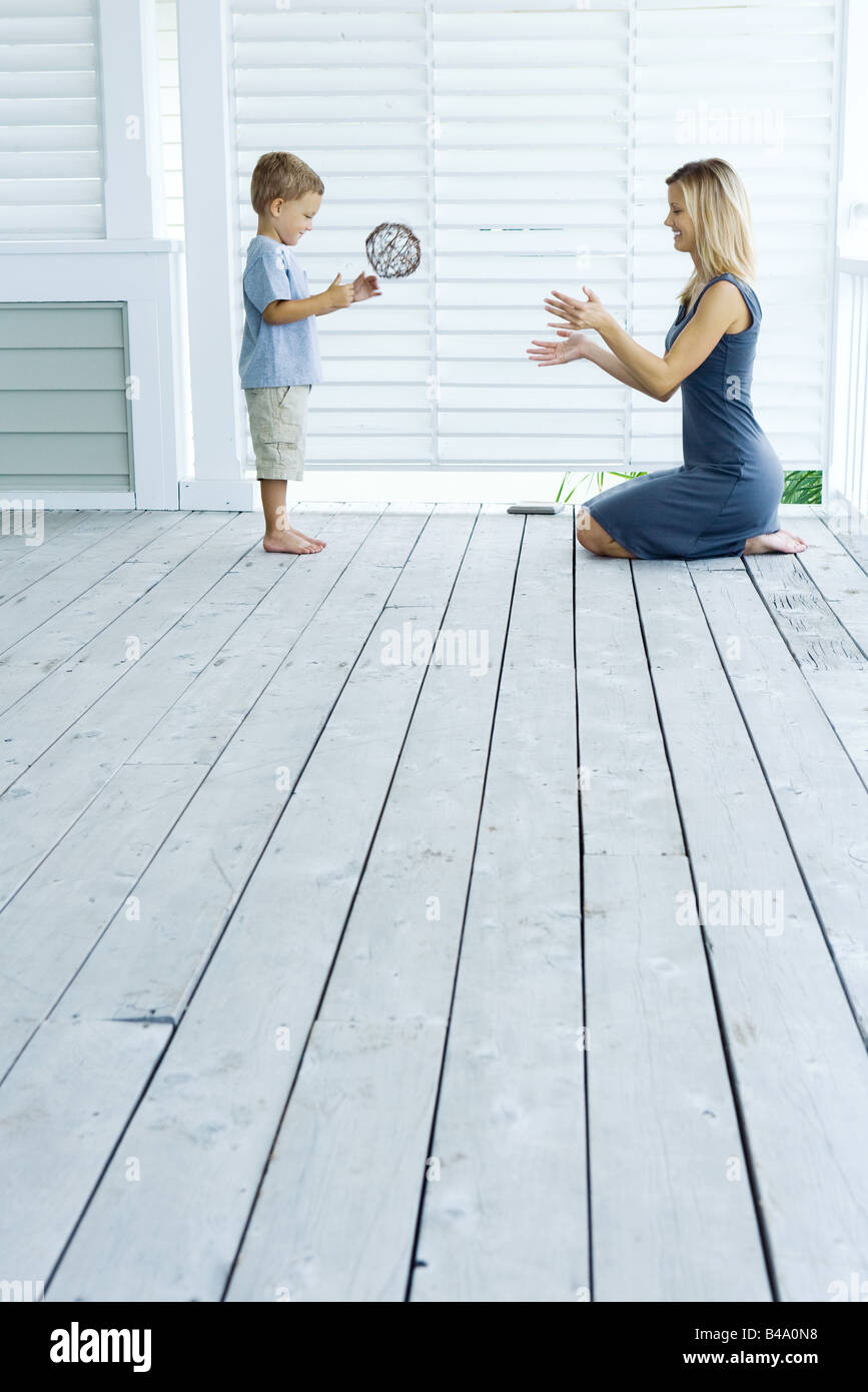 Mother and son playing catch on porch Stock Photo - Alamy