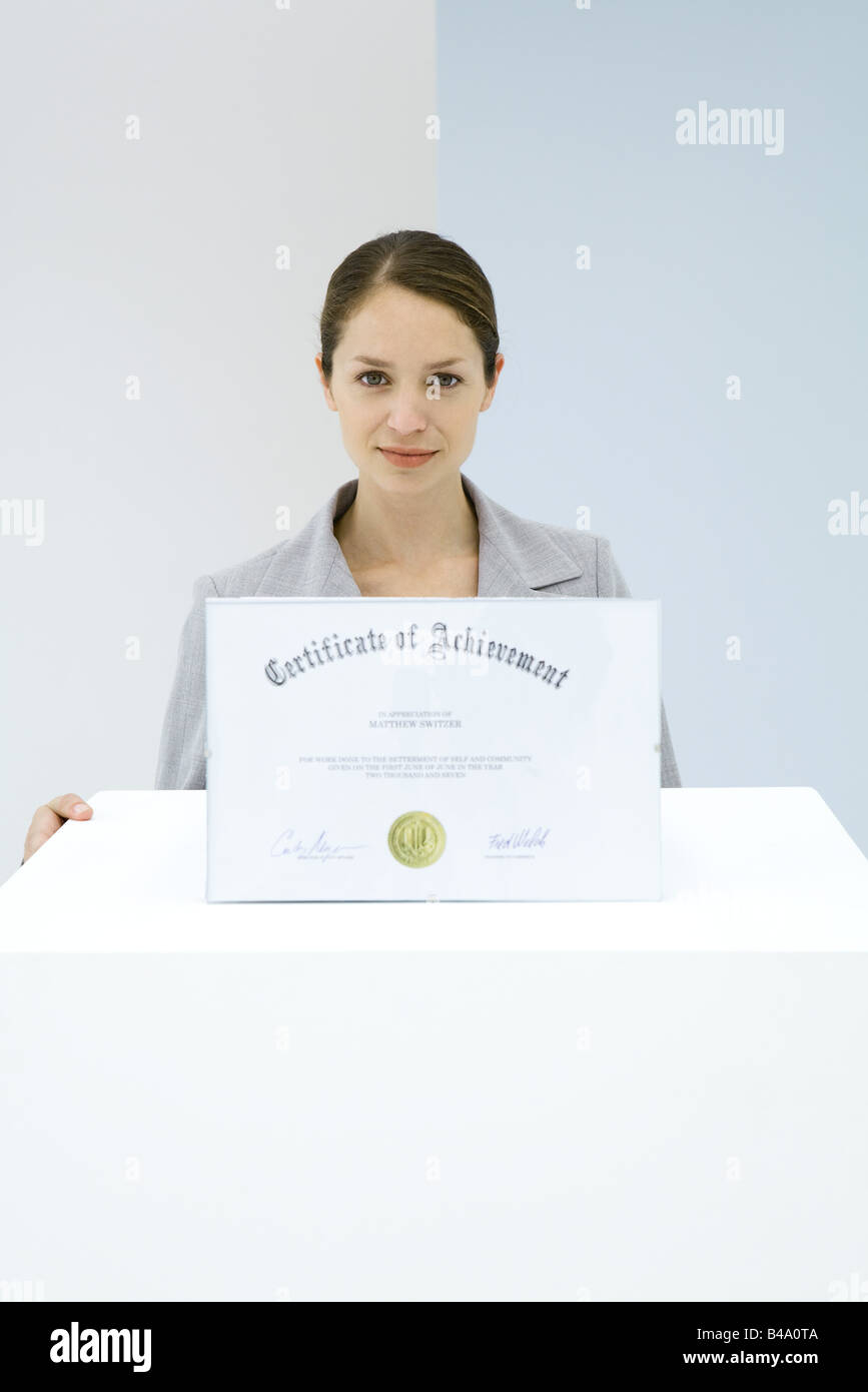 Woman displaying certificate of achievement Stock Photo - Alamy