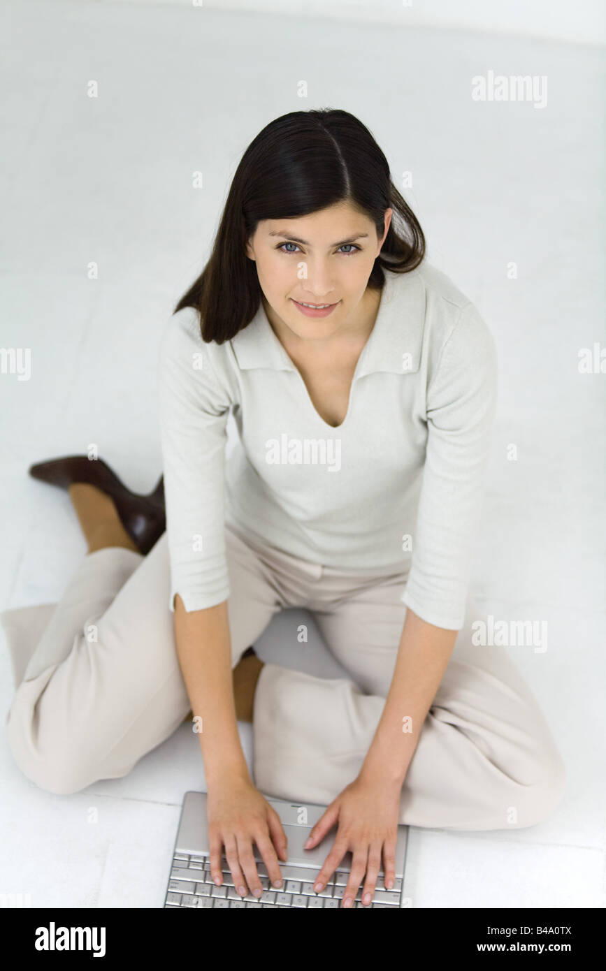 Businesswoman sitting on floor using laptop computer Stock Photo - Alamy