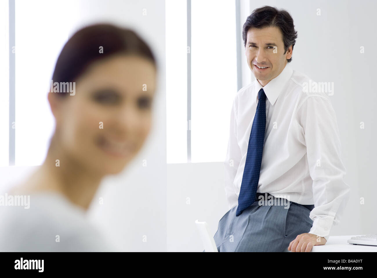 Professional man leaning against desk hi-res stock photography and ...