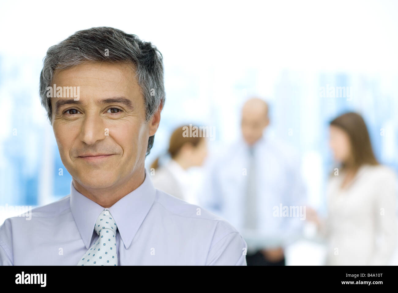 Business executive smiling at camera, portrait Stock Photo - Alamy