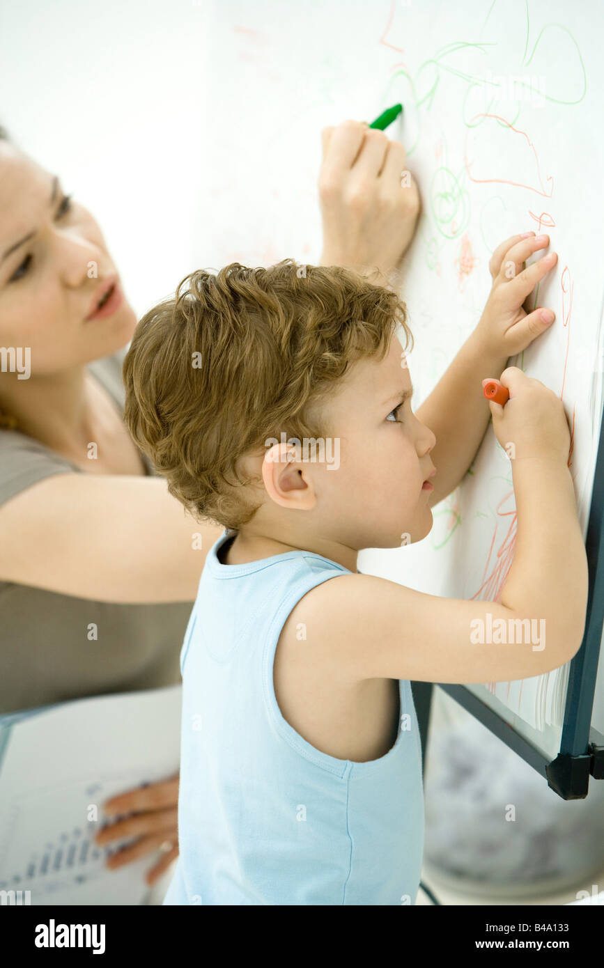 Mother and son drawing together, side view Stock Photo - Alamy