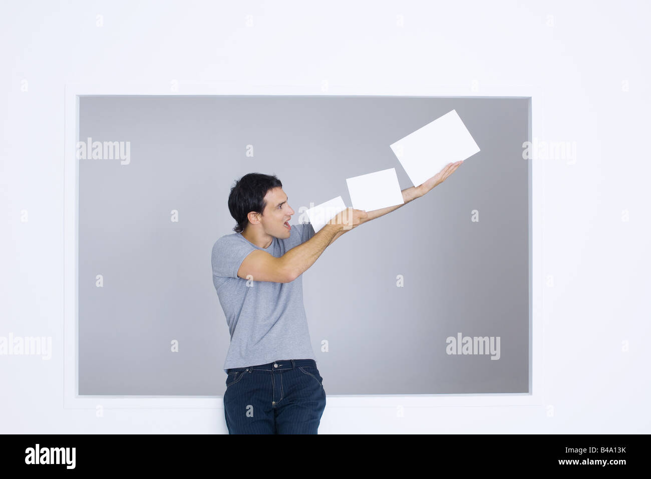 Man holding up blank papers, shouting Stock Photo - Alamy