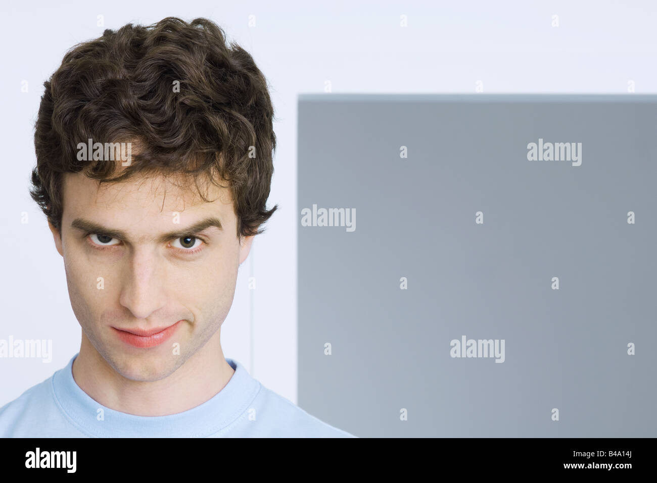 Man smirking at camera, one eyebrow raised Stock Photo - Alamy