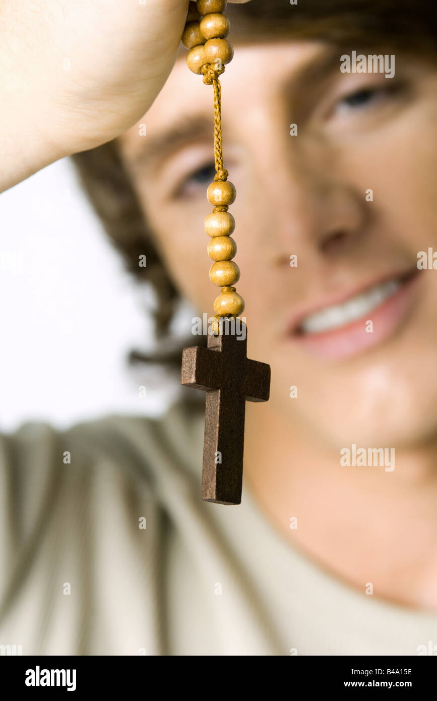 Man holding wooden rosary, focus on foreground Stock Photo - Alamy