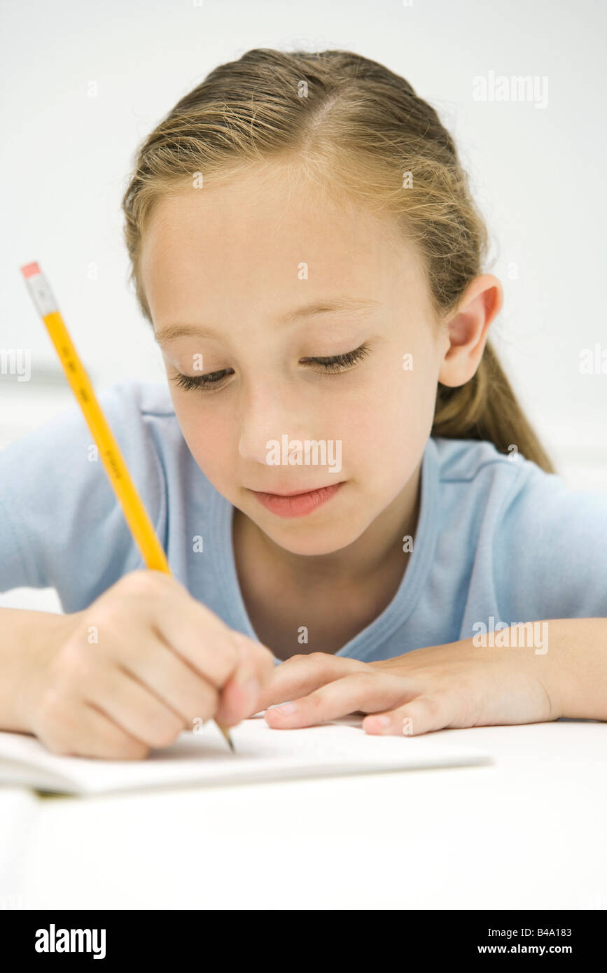 Girl writing with pencil, close-up Stock Photo - Alamy