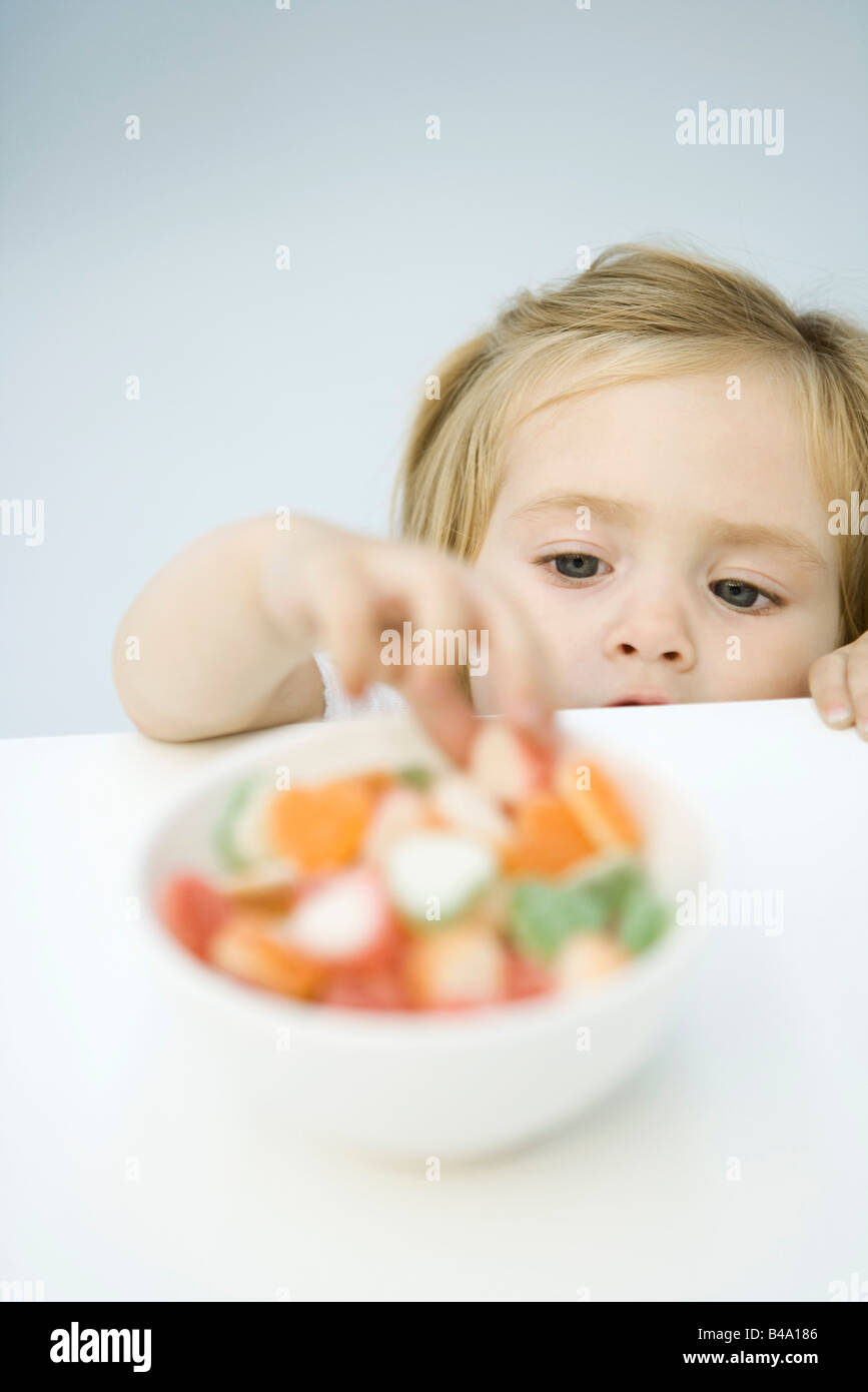 Kid reaching for candy hi-res stock photography and images - Alamy