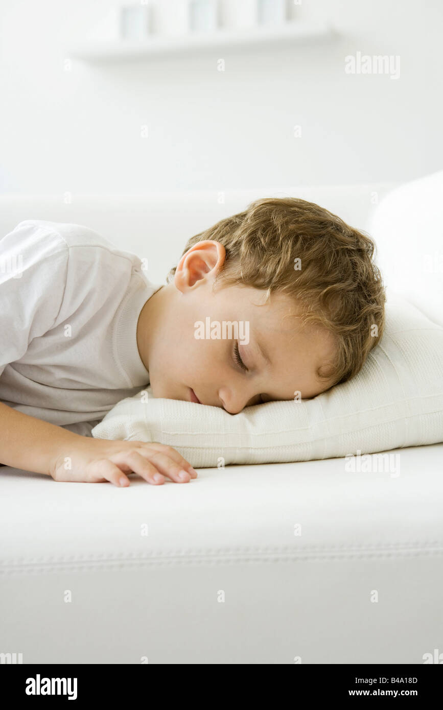 Little boy napping on bed, eyes closed Stock Photo - Alamy