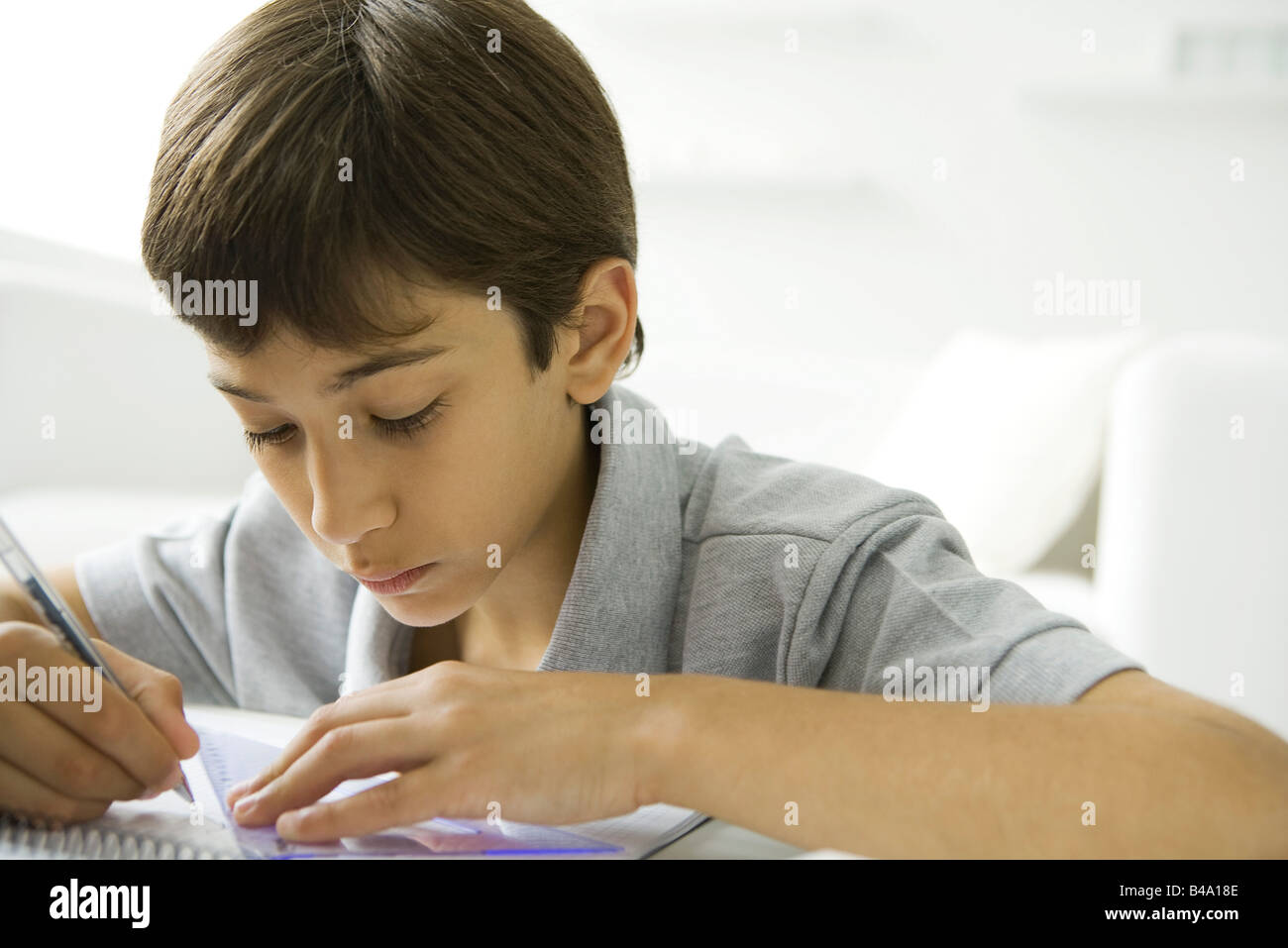 Boy doing homework, close-up Stock Photo - Alamy