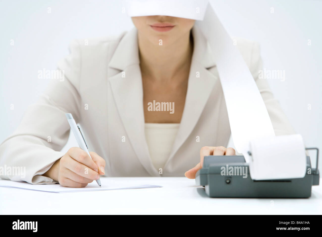 Accountant using adding machine, printout wrapped around her face like ...