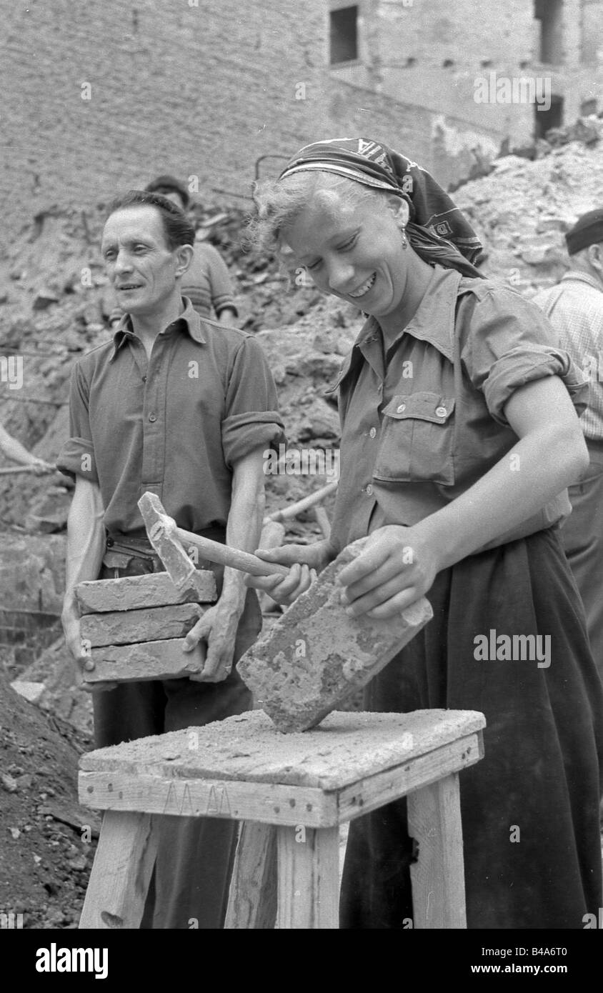 events, post war era, reconstruction, young woman working on a brick ...