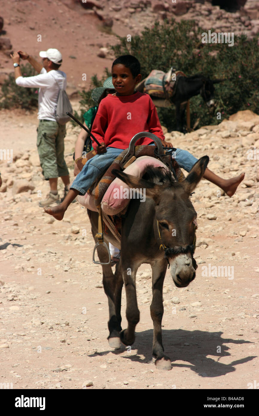 Arab boy riding a donkey, Petra, Jordan Stock Photo - Alamy