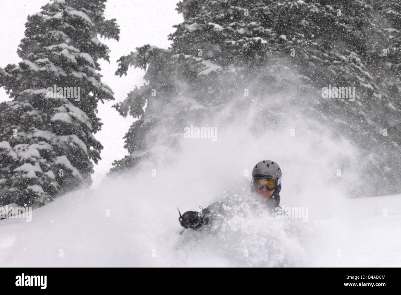 A man skiing in a spray of deep powder snow during a snow storm Stock ...