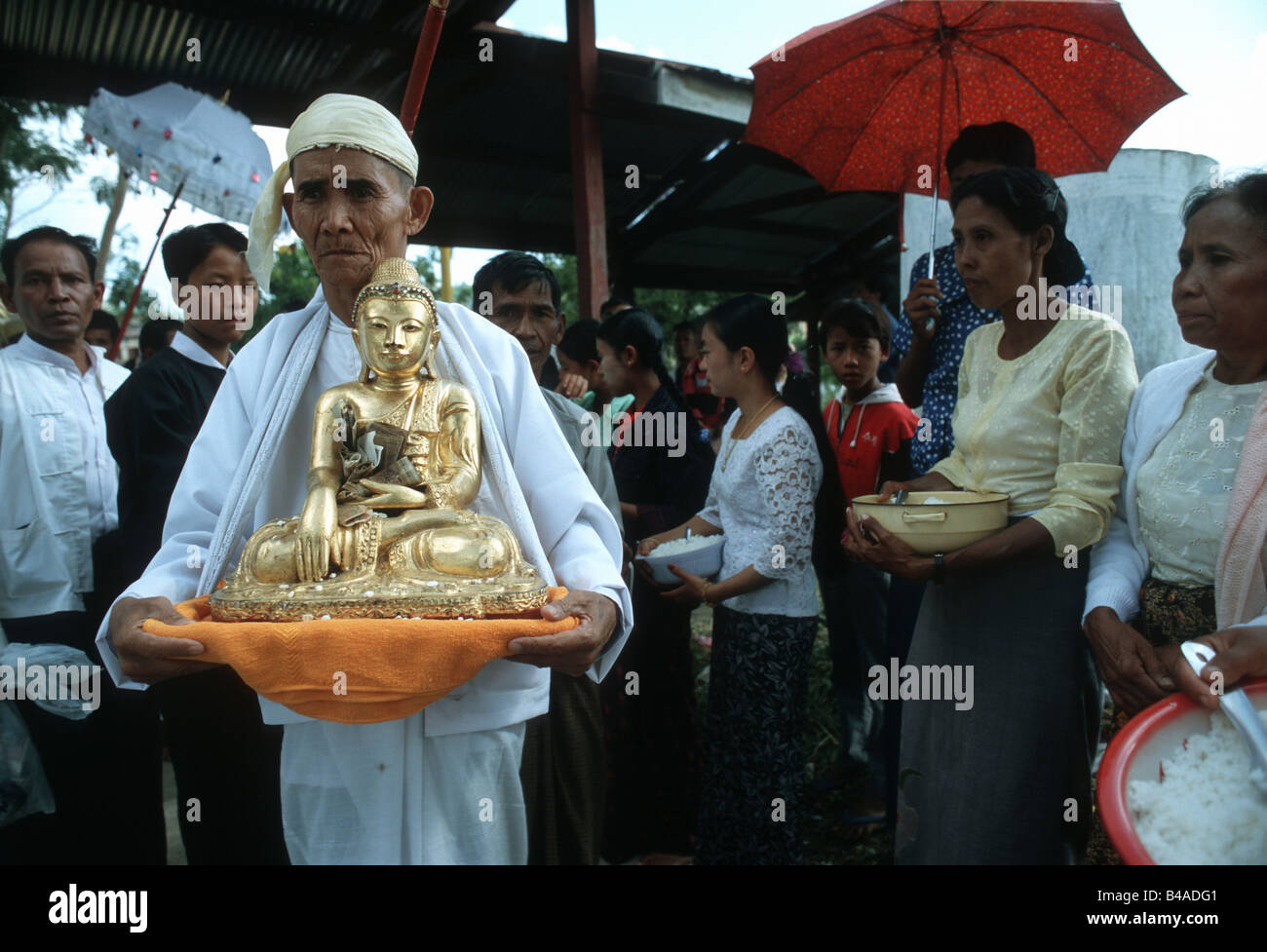 Man carrying a golden Buddha during a procession, Kalaw, Union of ...