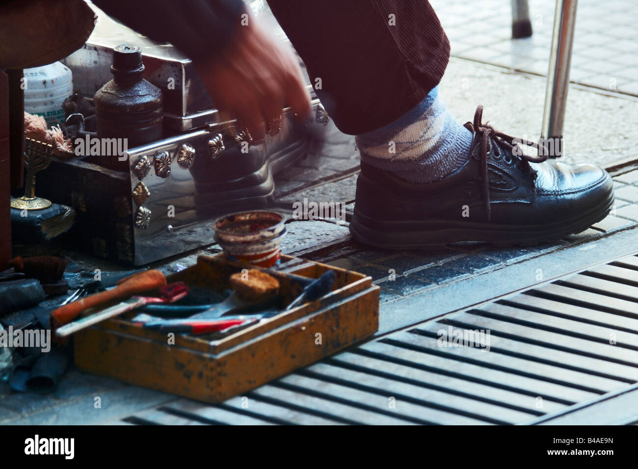 Shoe shine reaching for tools Stock Photo - Alamy