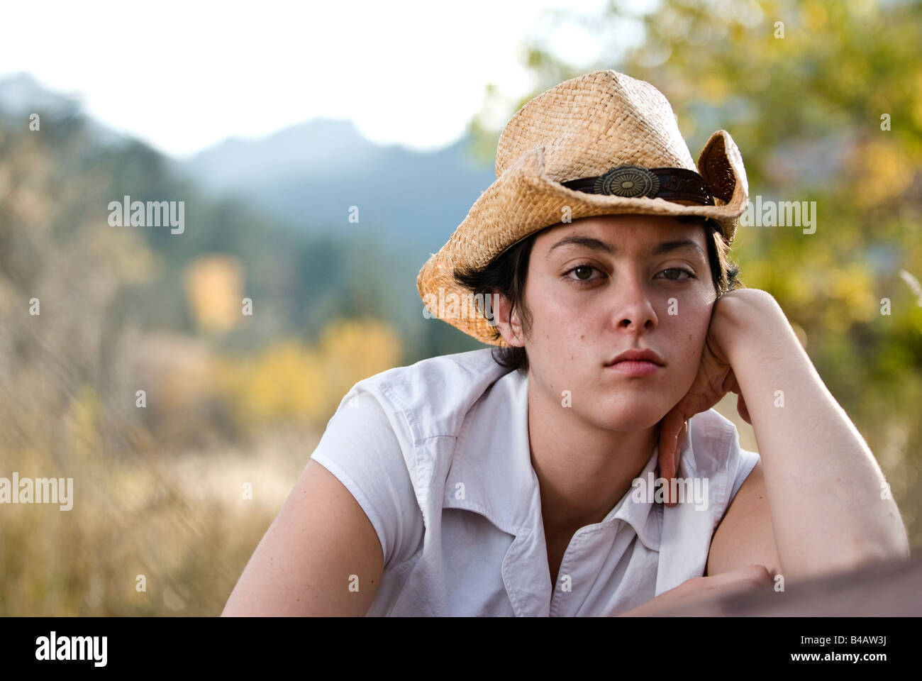 an 18 year old cowgirl, in the mountains, looks pensive Stock Photo - Alamy