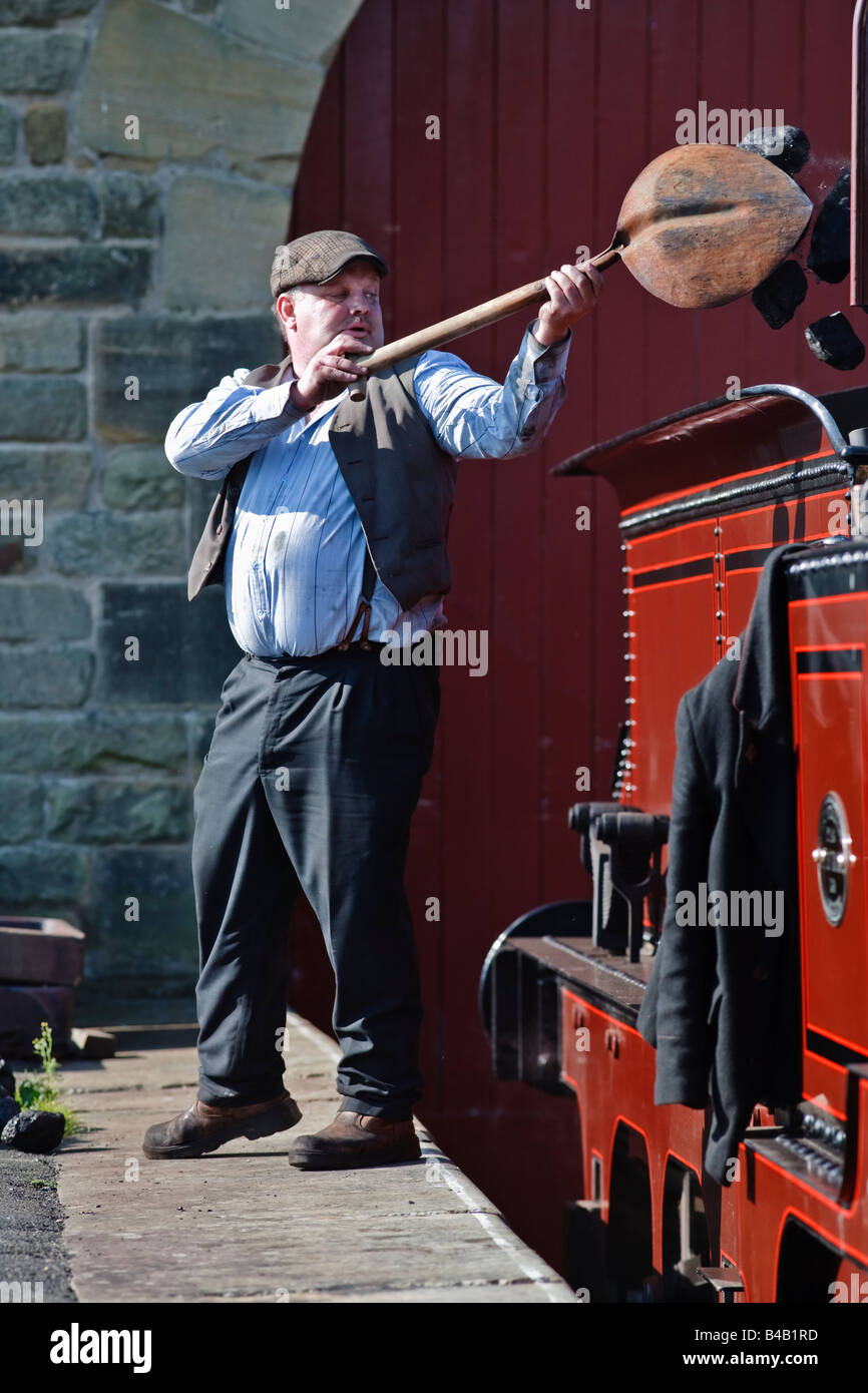 Stoker filling a steam engine tender with coal at the Beamish Open Air ...