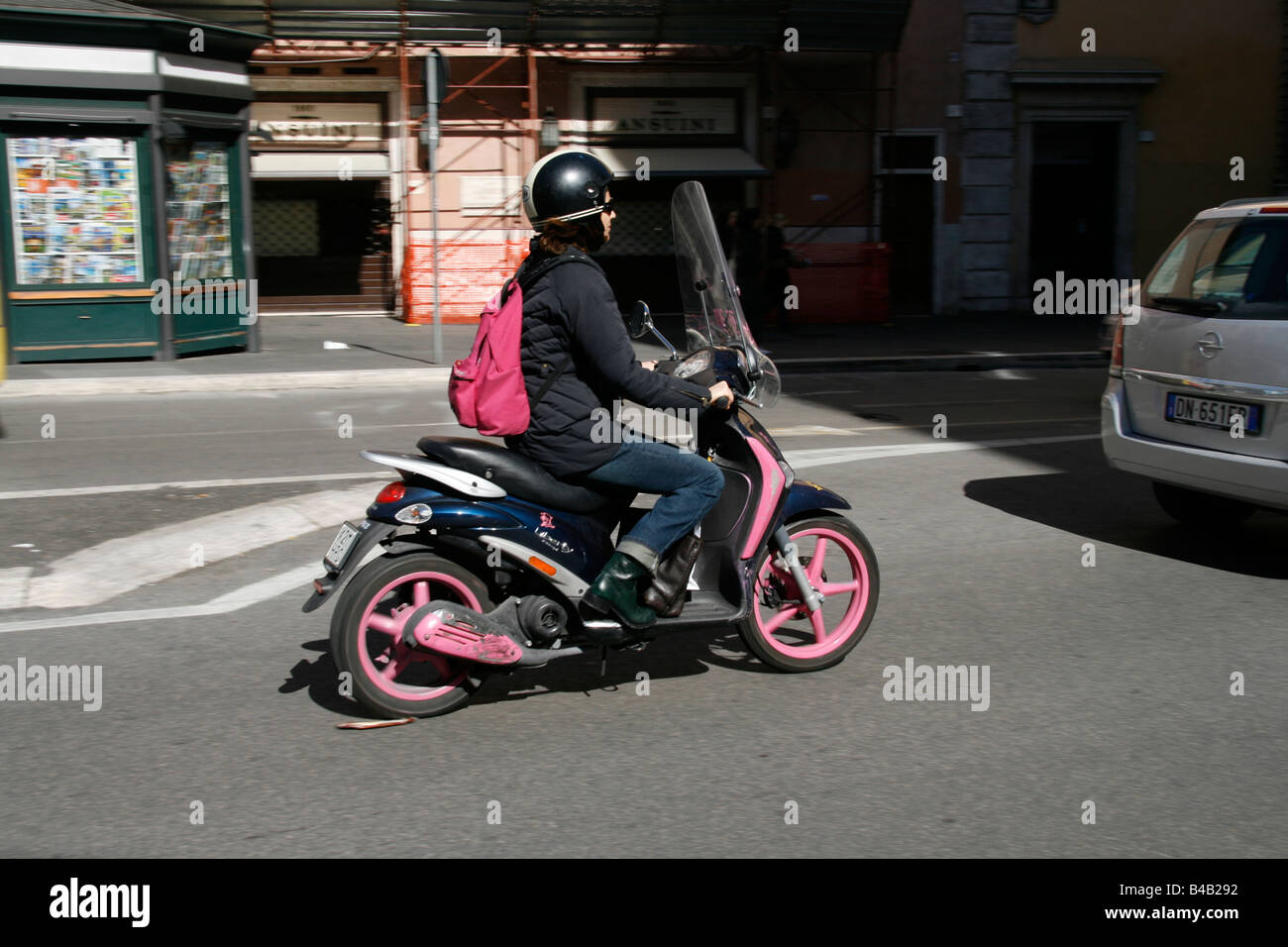 person riding scooter on street in rome italy Stock Photo - Alamy