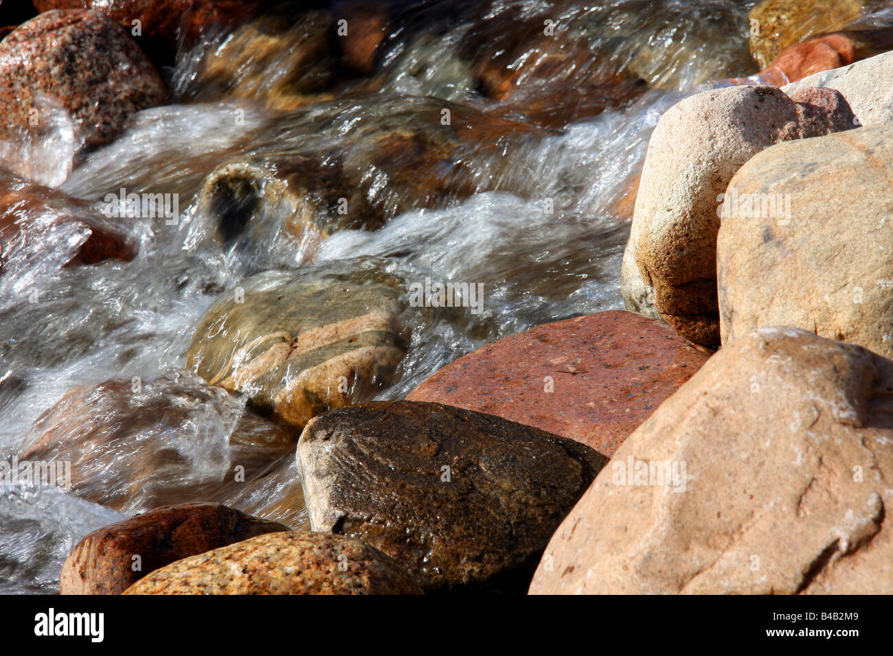 Water flowing over rocks in stream Stock Photo - Alamy